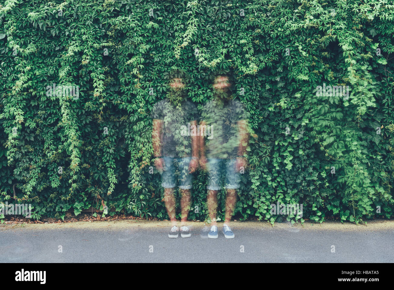 Double exposure portrait of transparent identical adult male twins and ...