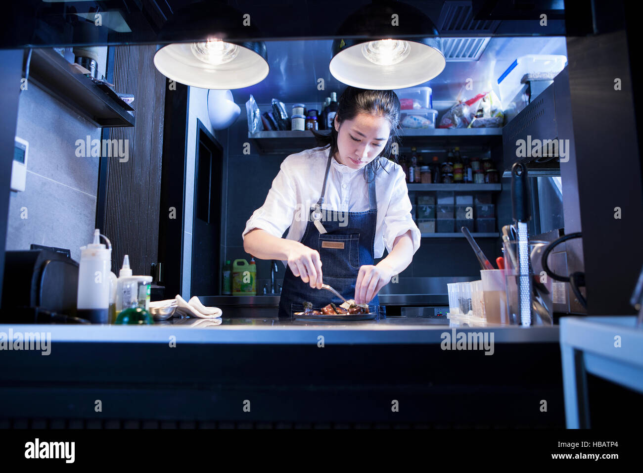 Chef in commercial kitchen preparing food Stock Photo - Alamy