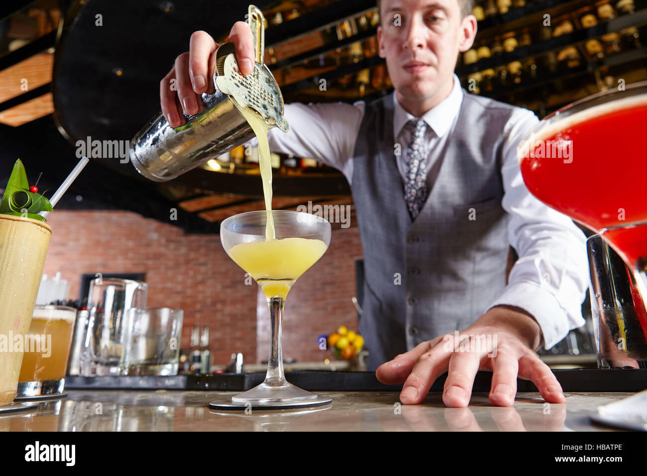 Bartender pouring cocktail Stock Photo - Alamy