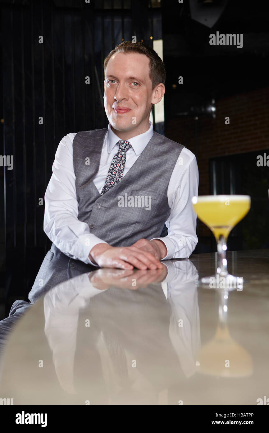 Man at bar with cocktail looking at camera smiling Stock Photo - Alamy
