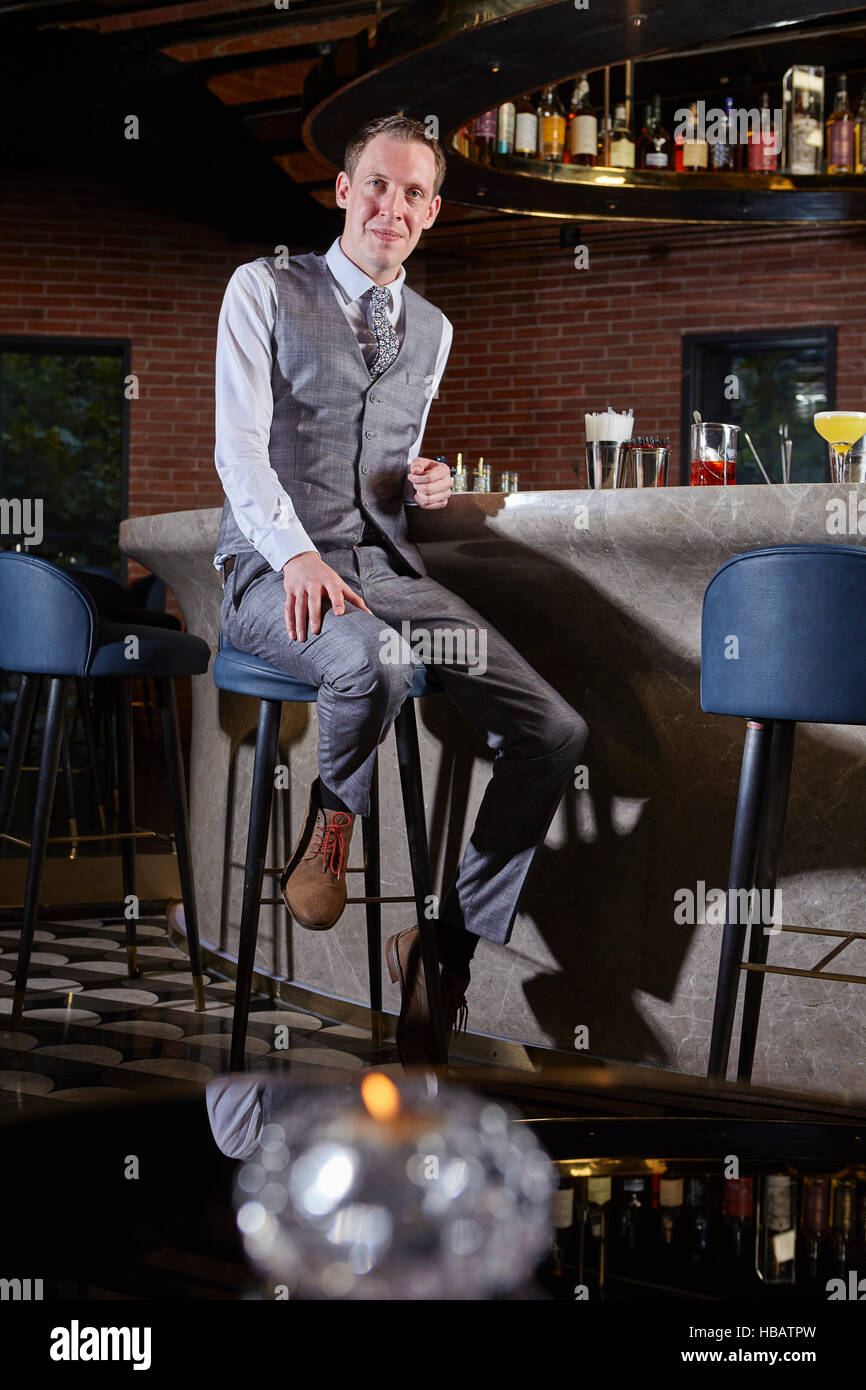 Man at bar looking at camera smiling Stock Photo - Alamy