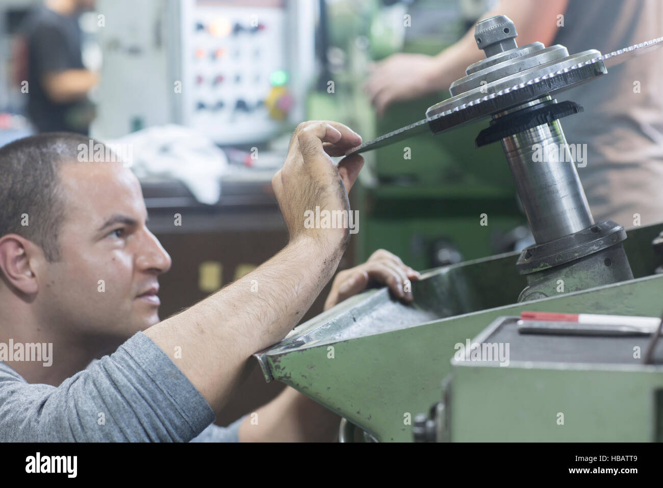 Man checking rotary blade on grinding machine Stock Photo - Alamy