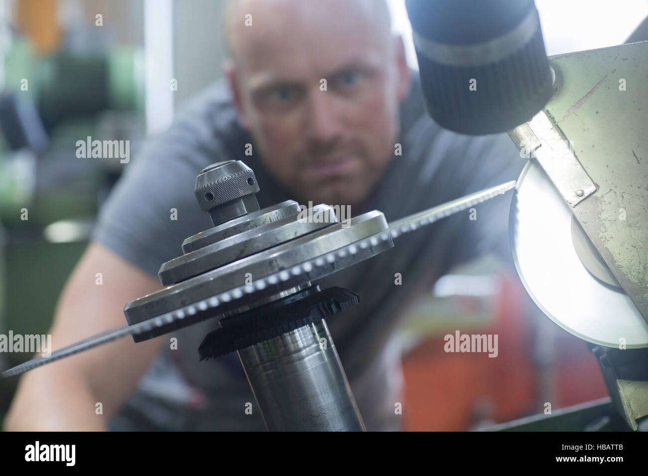 Man checking rotary blade on grinding machine Stock Photo - Alamy
