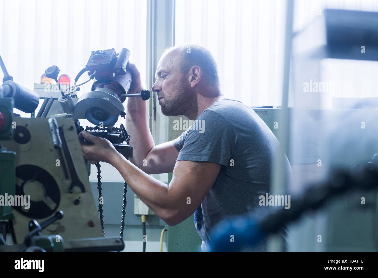 Man working in grinding workshop Stock Photo - Alamy