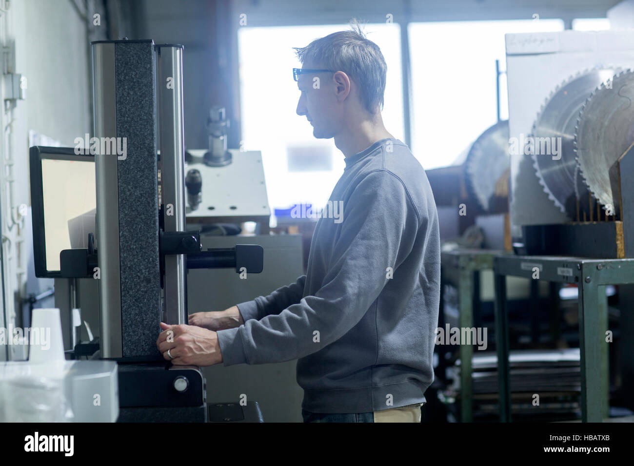 Man working in grinding workshop Stock Photo - Alamy
