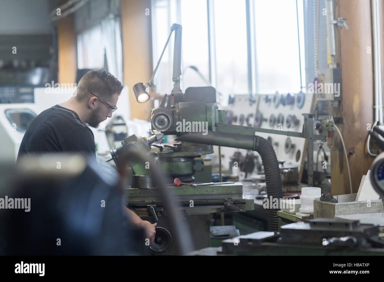 Man working in grinding workshop Stock Photo - Alamy