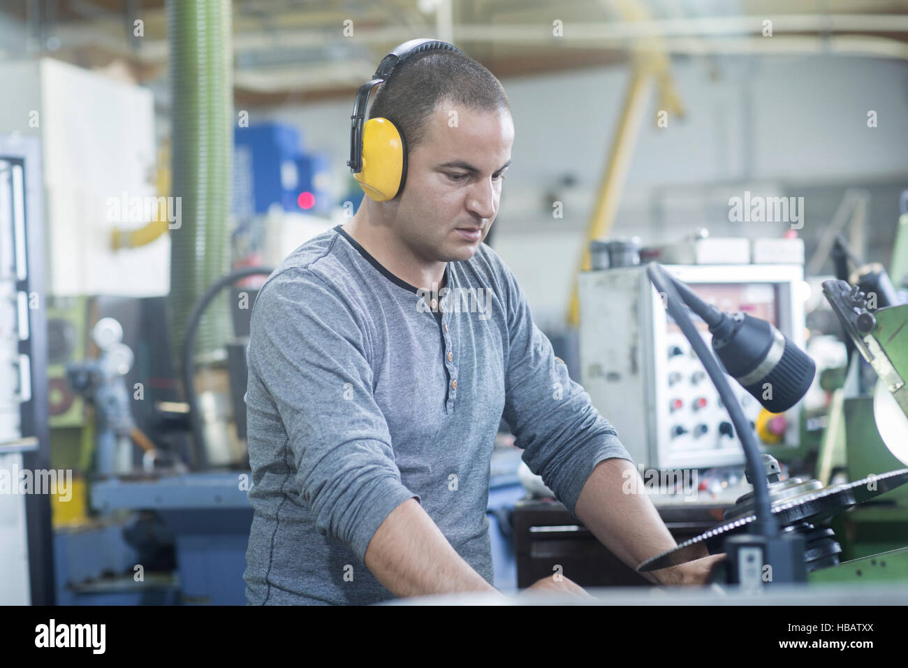 Man working in grinding workshop Stock Photo - Alamy