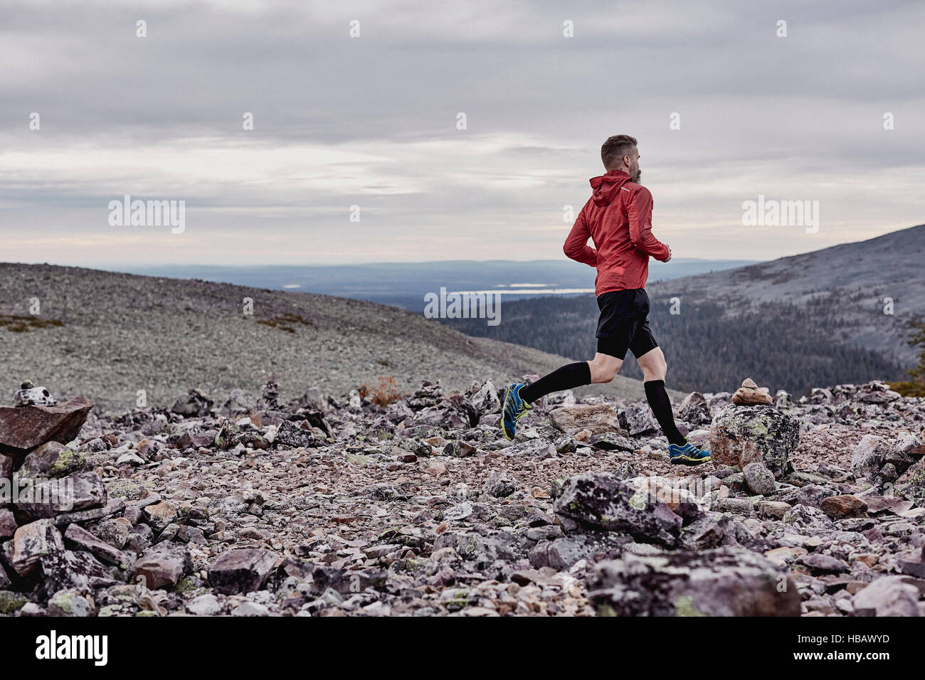 Man running on rocky cliff top, Kesankitunturi, Lapland, Finland Stock ...