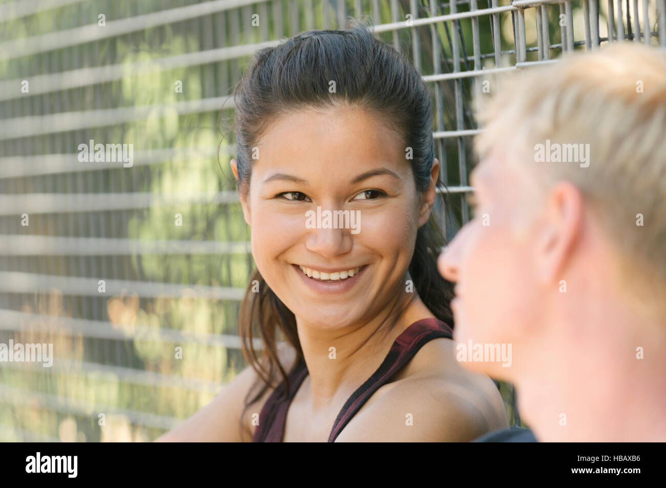 Couple talking by wire fence Stock Photo - Alamy