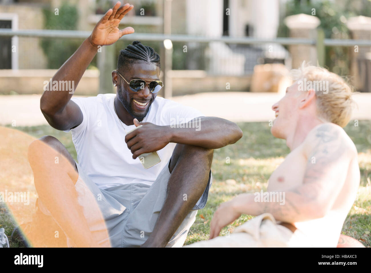 Two young men high fiving each other in park Stock Photo - Alamy