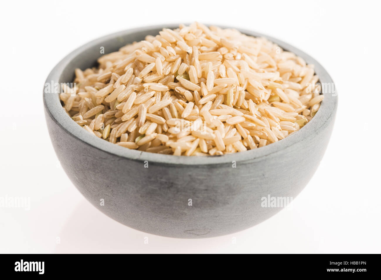 brown rice in a bowl isolated on white background Stock Photo - Alamy