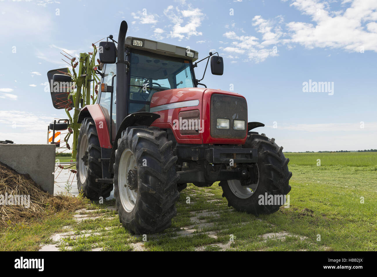 red tractor with tedder Stock Photo - Alamy