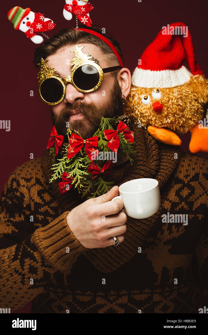 Funny bearded man in a New Year's image as Santa Claus with decorations ...