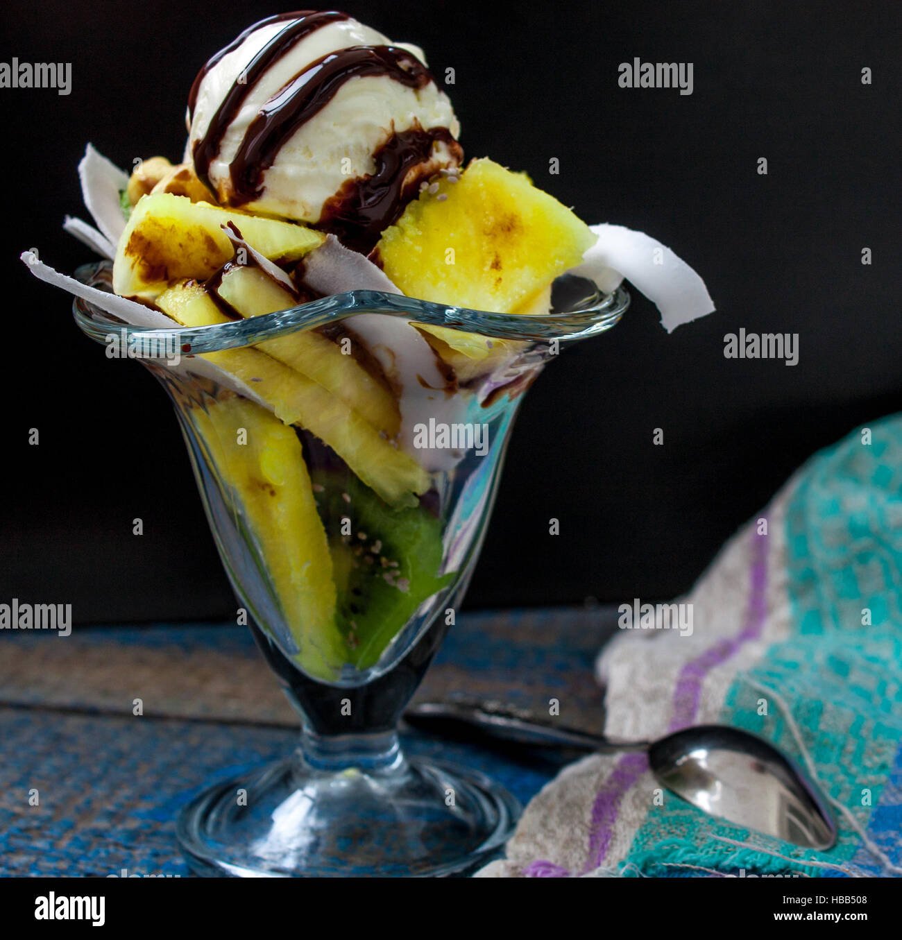 The ball of ice cream in a dessert glass with fruits and chocolate on a ...