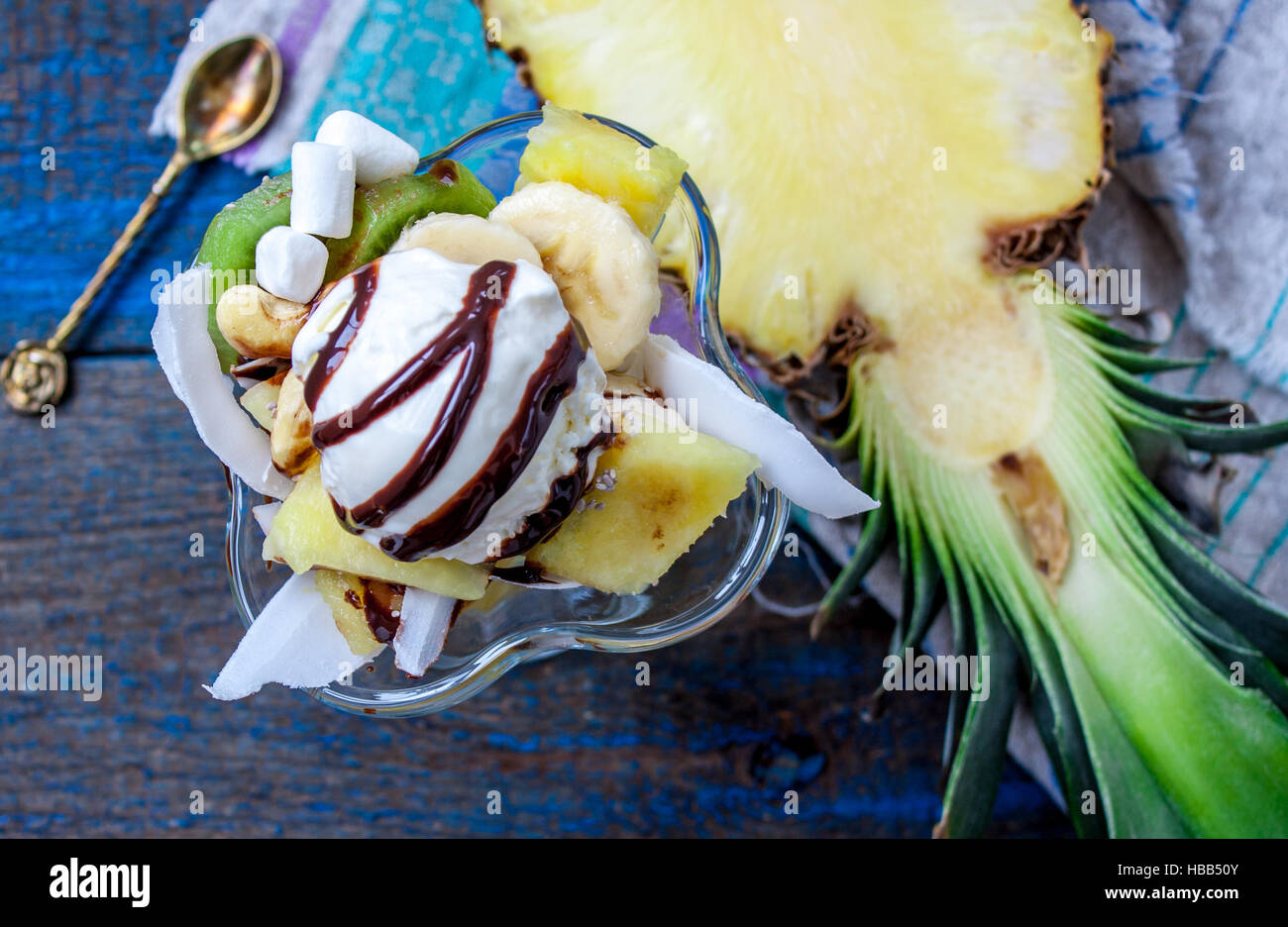 The ball of ice cream in a dessert glass with fruits and chocolate on a ...