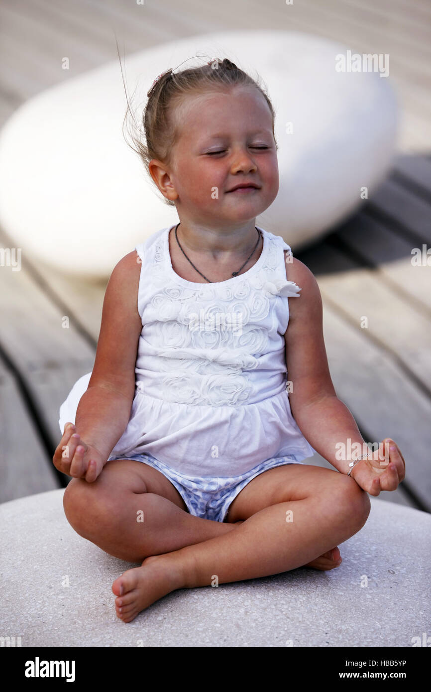 Adorable little girl doing yoga Stock Photo - Alamy
