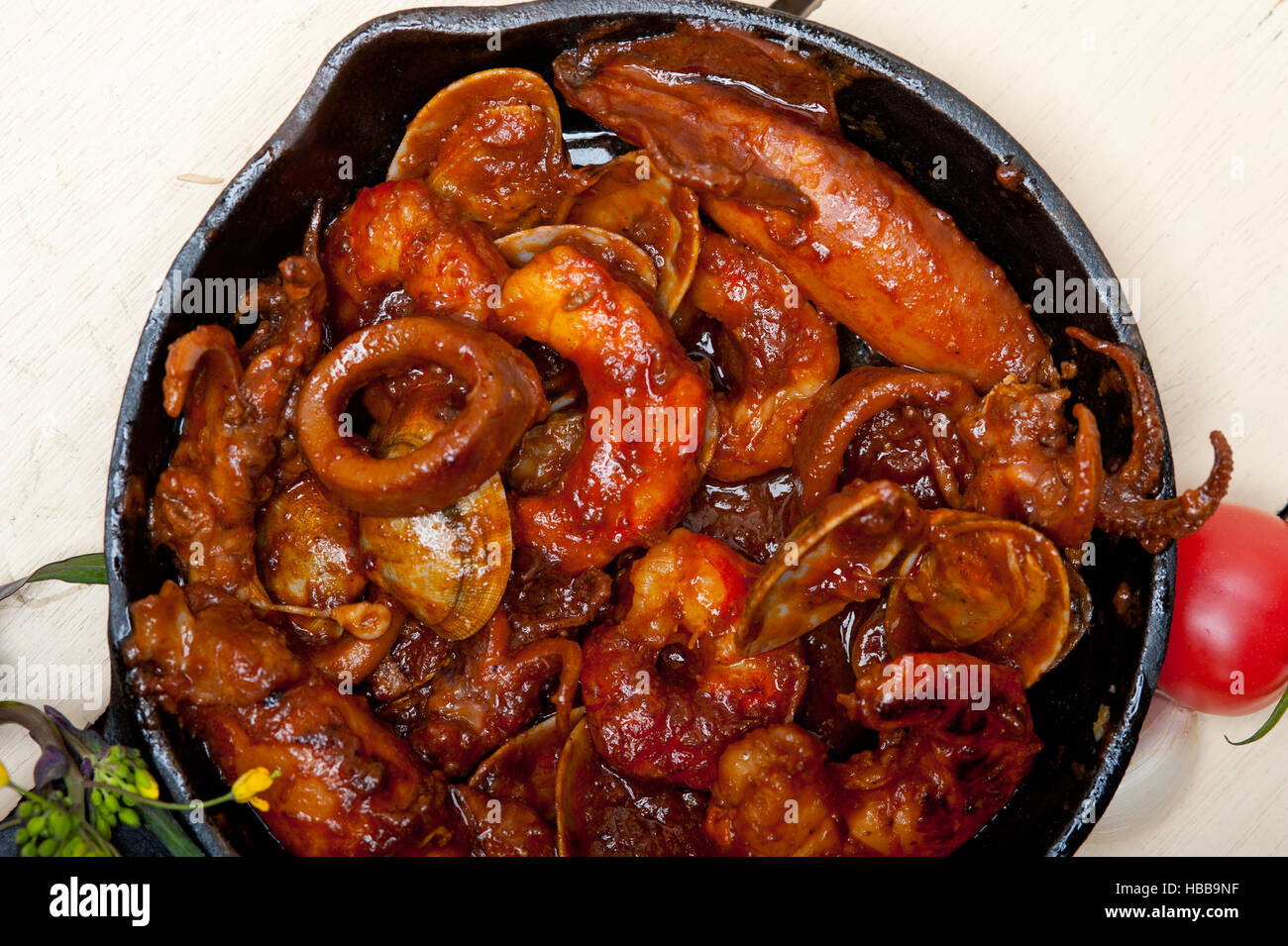 fresh seafoos stew on an iron skillet Stock Photo - Alamy