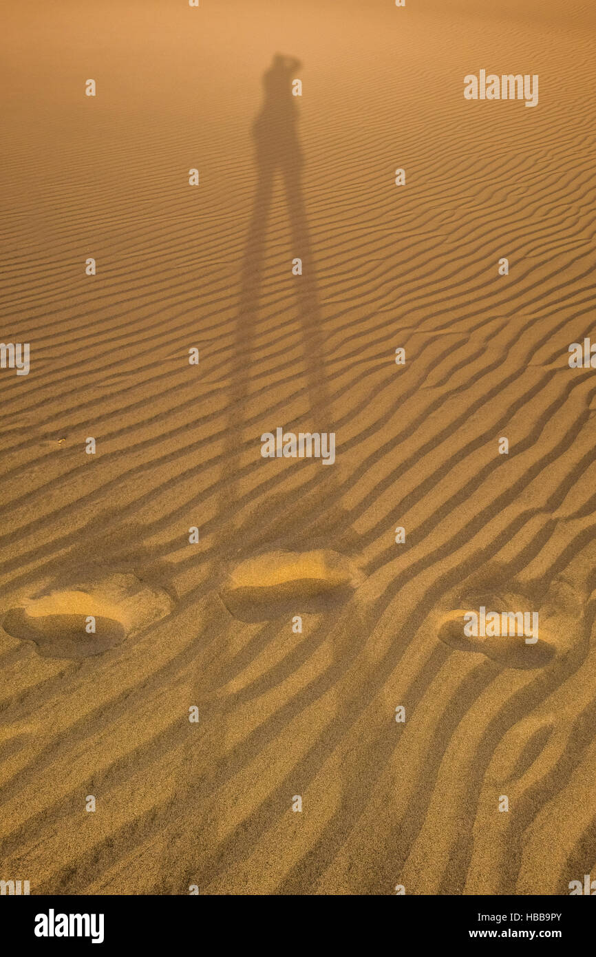 Shadow of a photographer taking picture of the sand dunes in the ...
