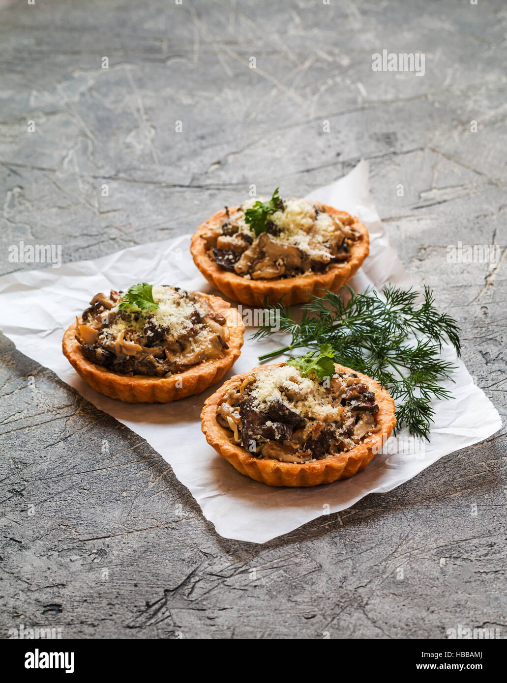 Homemade savory autumn tarts with fresh seasonal mushrooms in a crisp ...