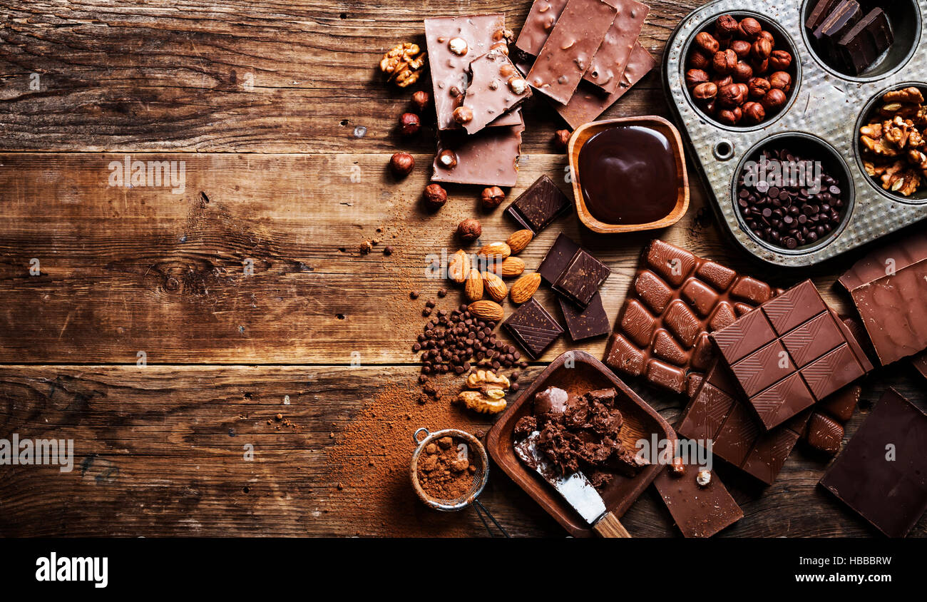 Assortment of different chocolate types on wooden background, top view ...