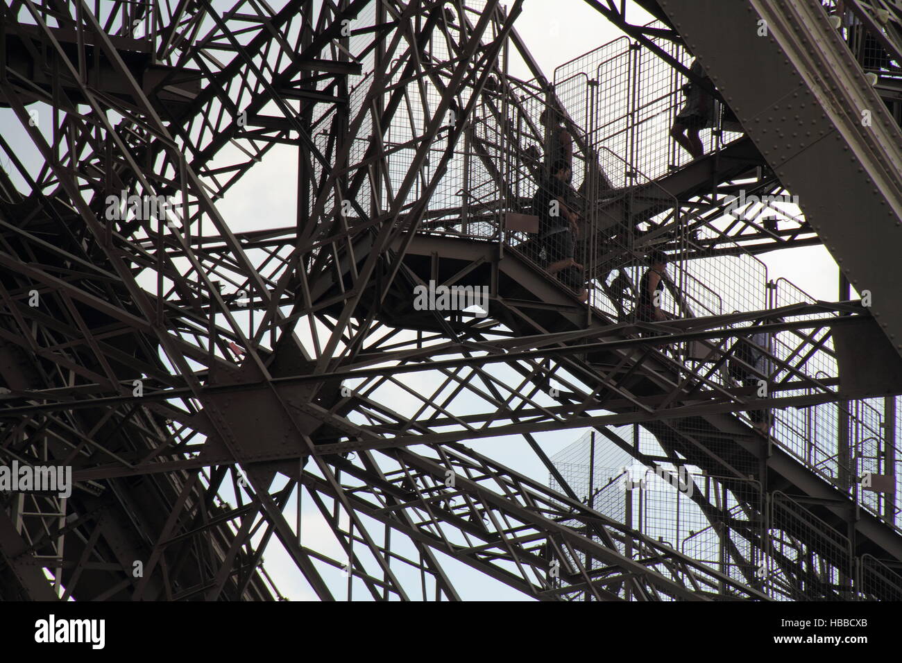 Tourists walk down the steps from the first level of the Eiffel Tower ...