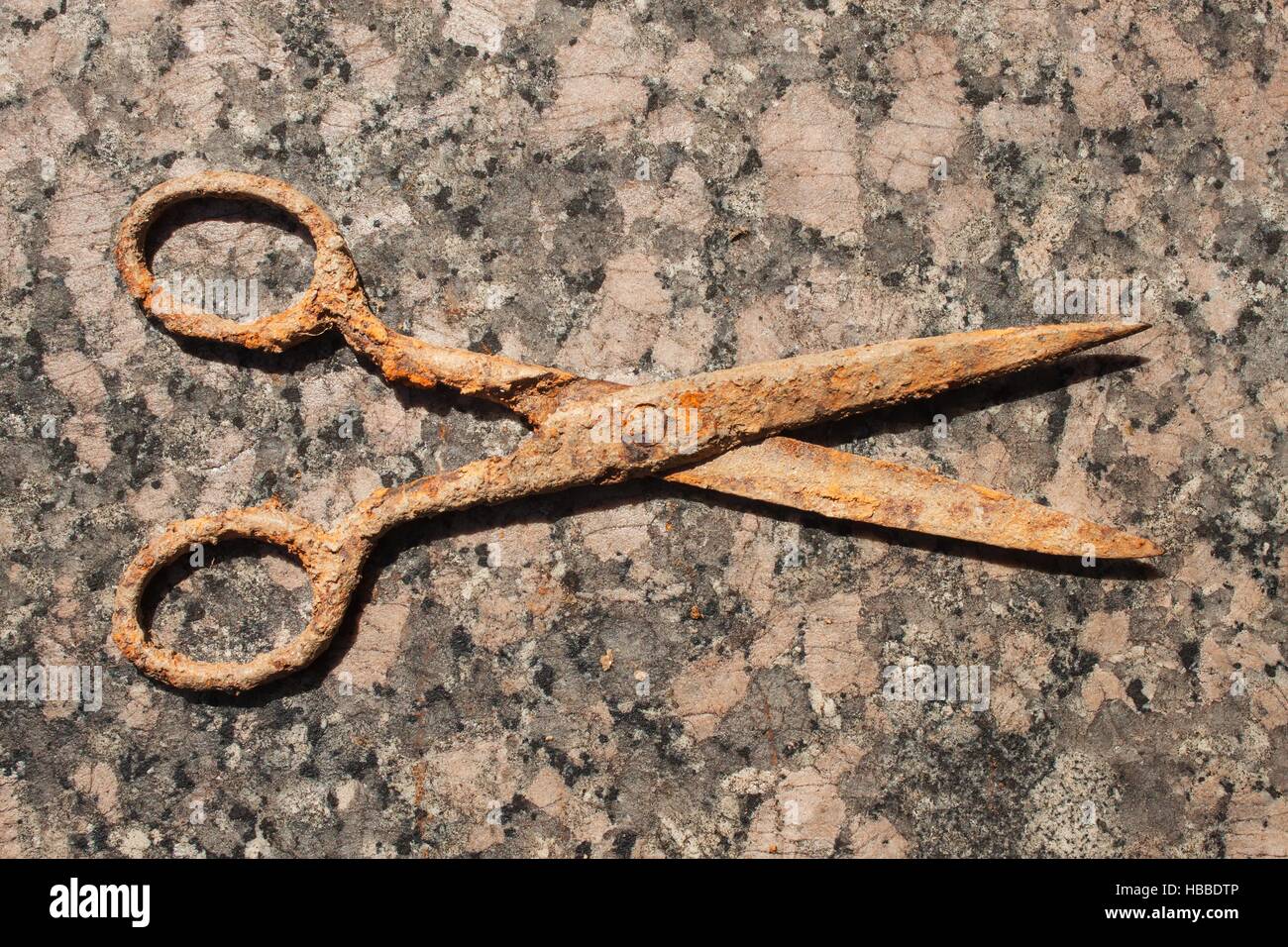 Old rusty scissors on a granite countertop. Old tool tailor Stock Photo ...