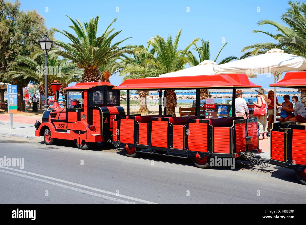 Tourists aboard a red land train along the promenade, Rethymno, Crete ...
