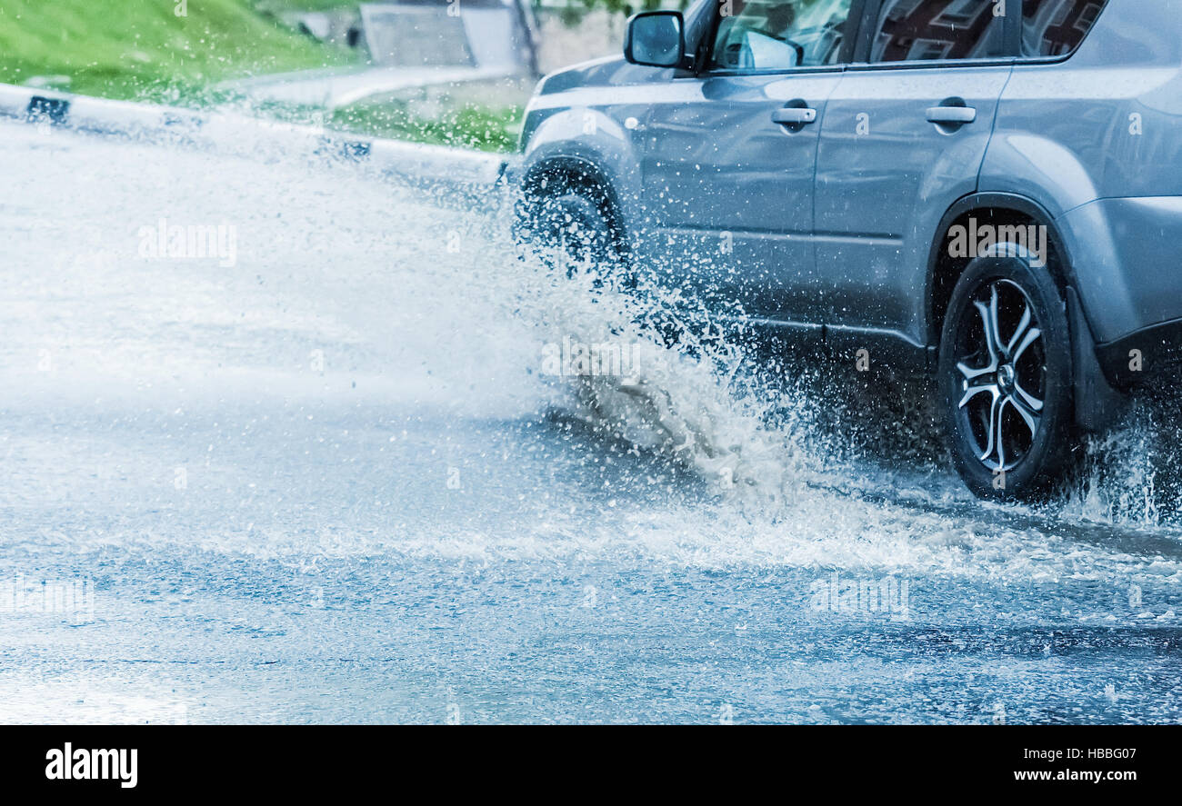 car rain puddle splashing water Stock Photo - Alamy