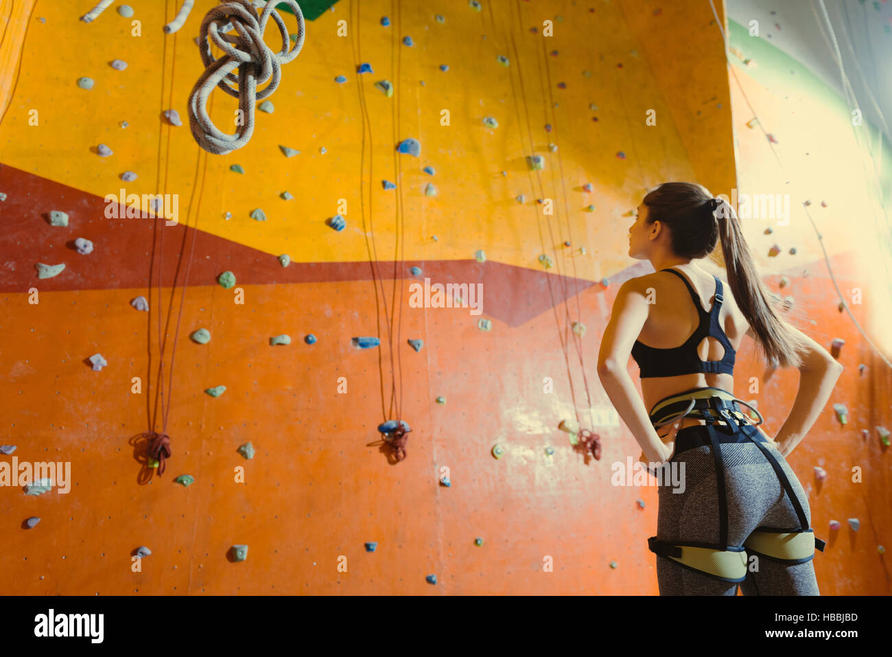 Young woman standing in a climbing gym Stock Photo - Alamy