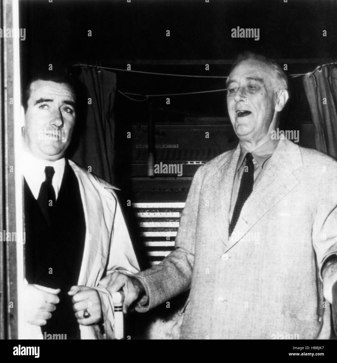President Franklin D. Roosevelt (right), emerging from a voting booth ...