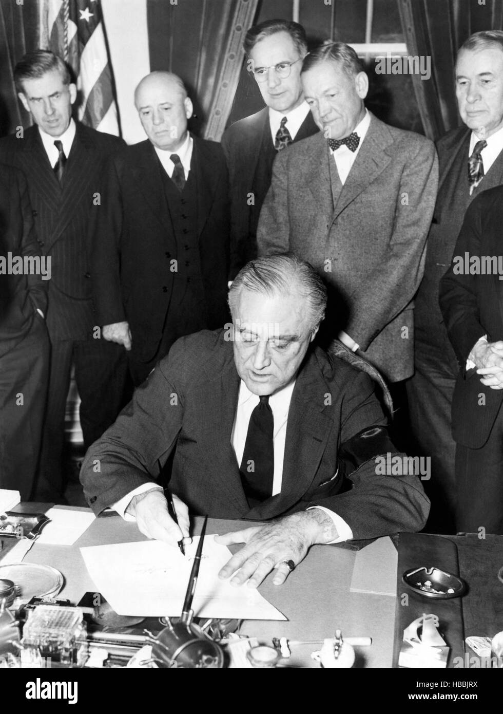 President Franklin D. Roosevelt (front), signing the declaration of war ...