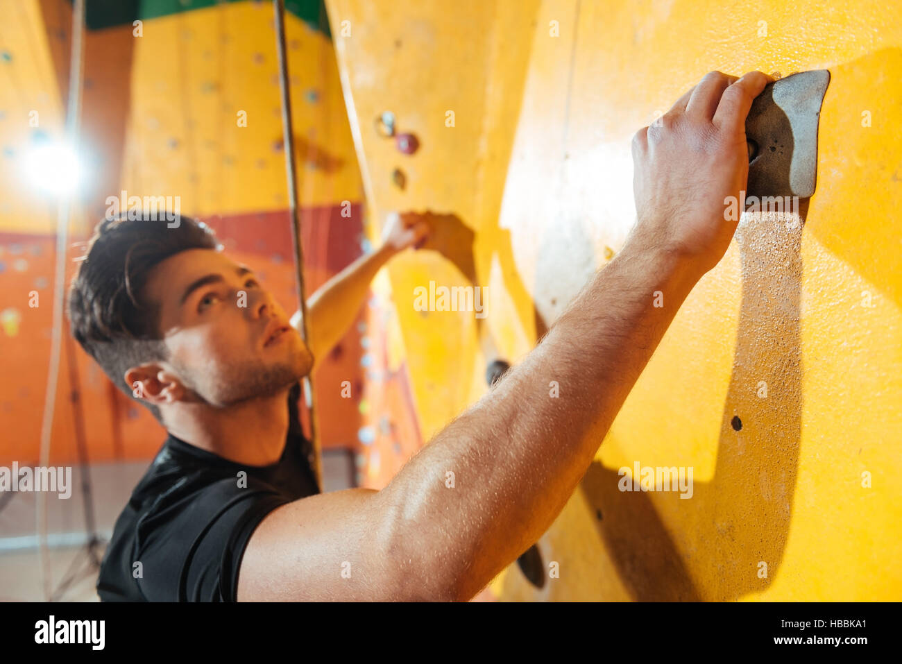 Active man training in climbing gym Stock Photo - Alamy