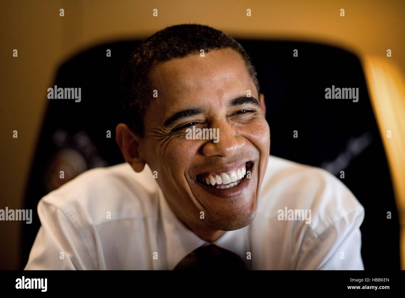 President Barack Obama laughs during an interview with a news magazine ...