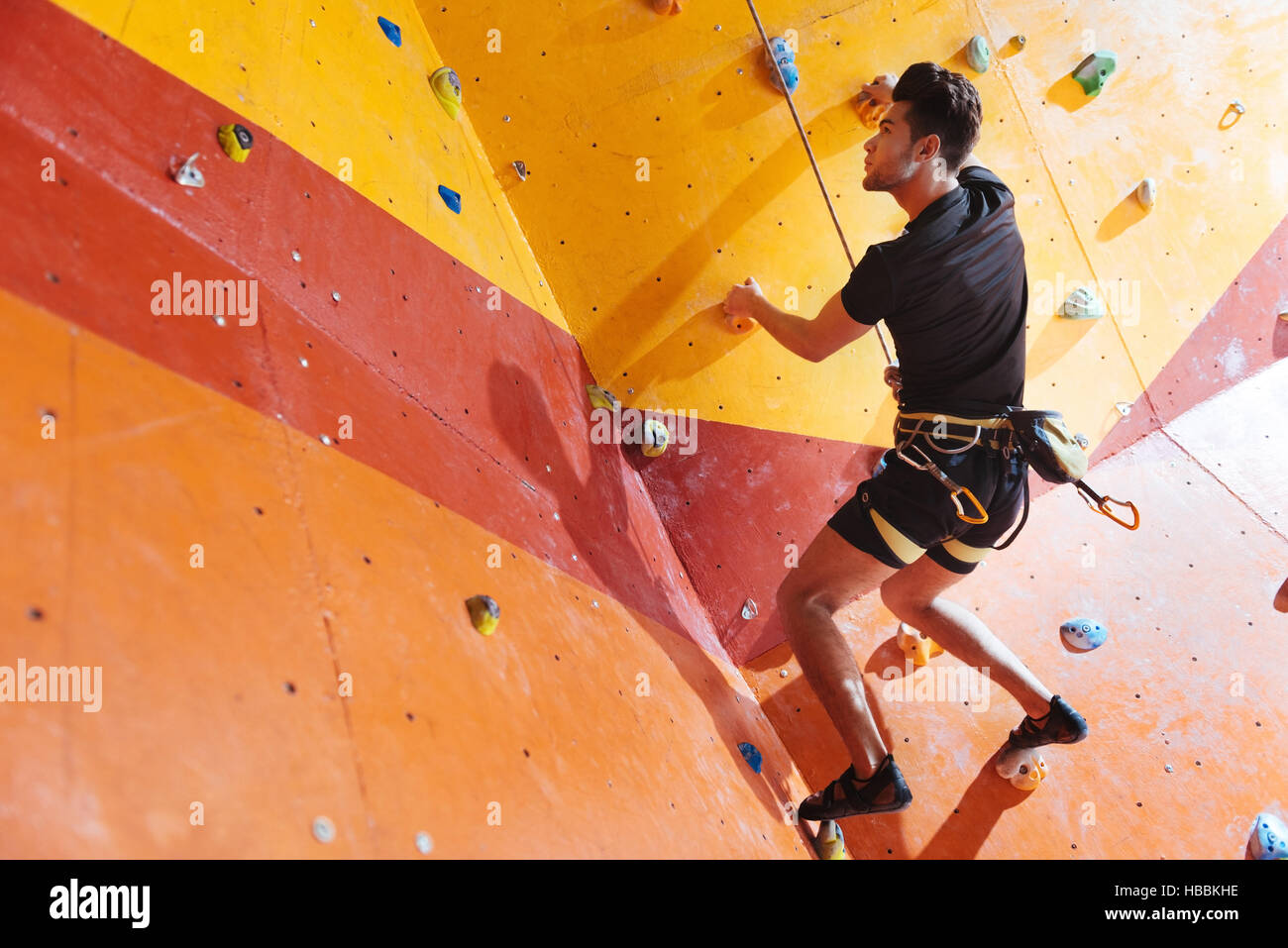 Handsome man training hard in climbing gym Stock Photo - Alamy