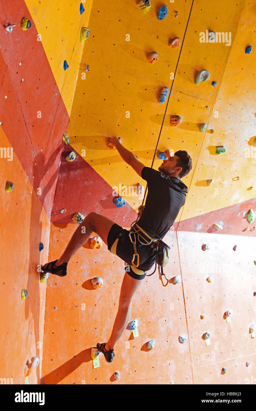 Athletic man training hard in climbing gym Stock Photo - Alamy