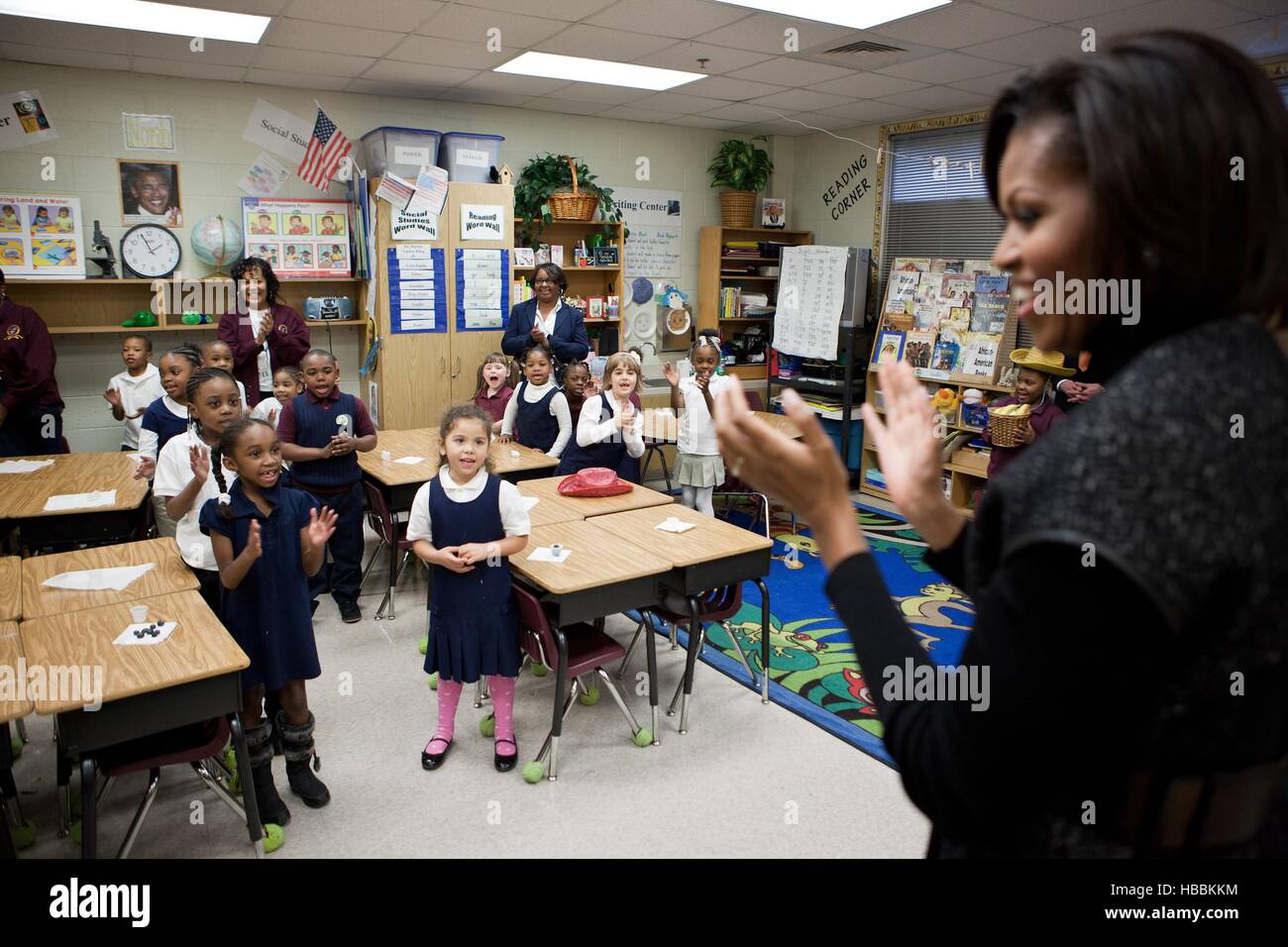 First Lady Michelle Obama claps along with students as they sing during ...