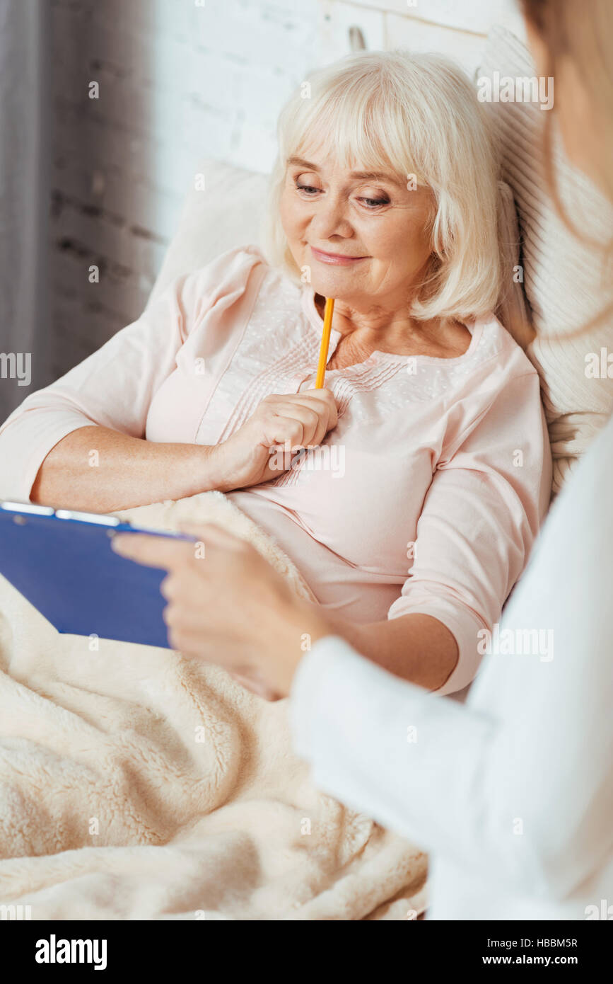 Kind professional doctor taking care of an old woman Stock Photo - Alamy
