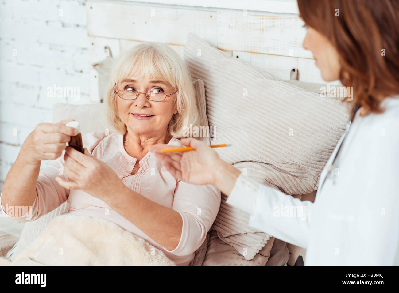 Professioanl doctor vising sick elderly woman at home Stock Photo - Alamy