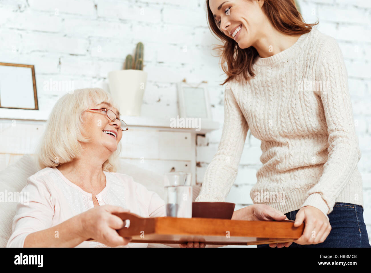 Cheerful caring woman takign care of her grandmother Stock Photo - Alamy