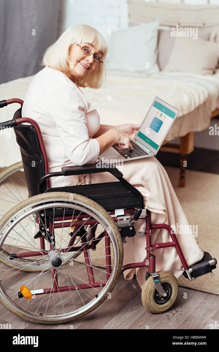 Joyful disabled woman using the Internet at home Stock Photo - Alamy