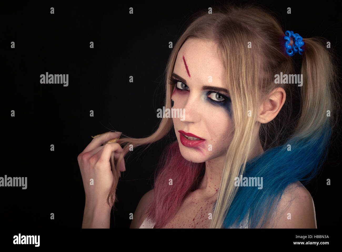 Cosplayer girl in Harley Quinn Halloween costume Stock Photo - Alamy