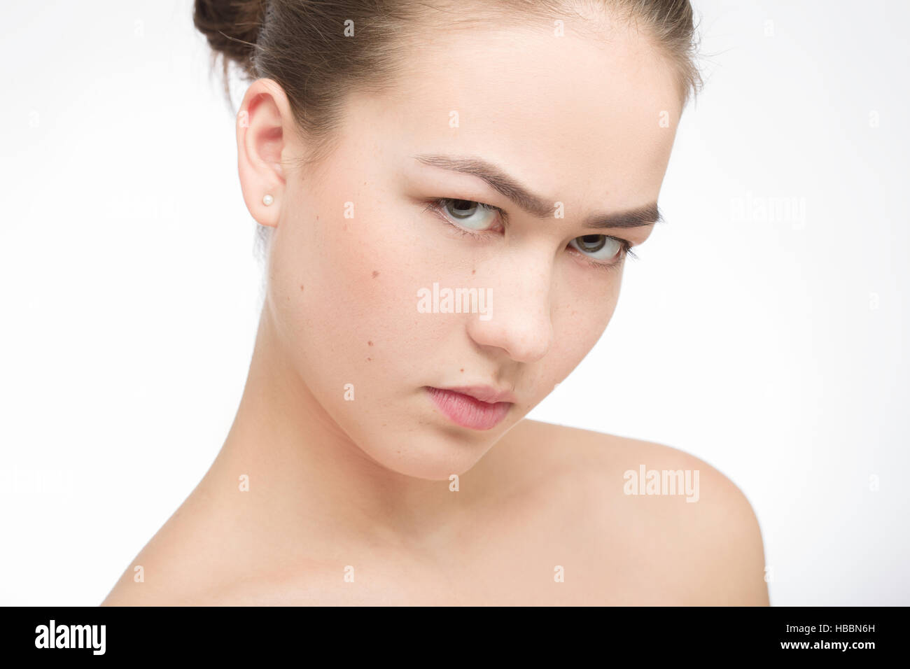 angry beautiful girl looking at camera on white background Stock Photo ...