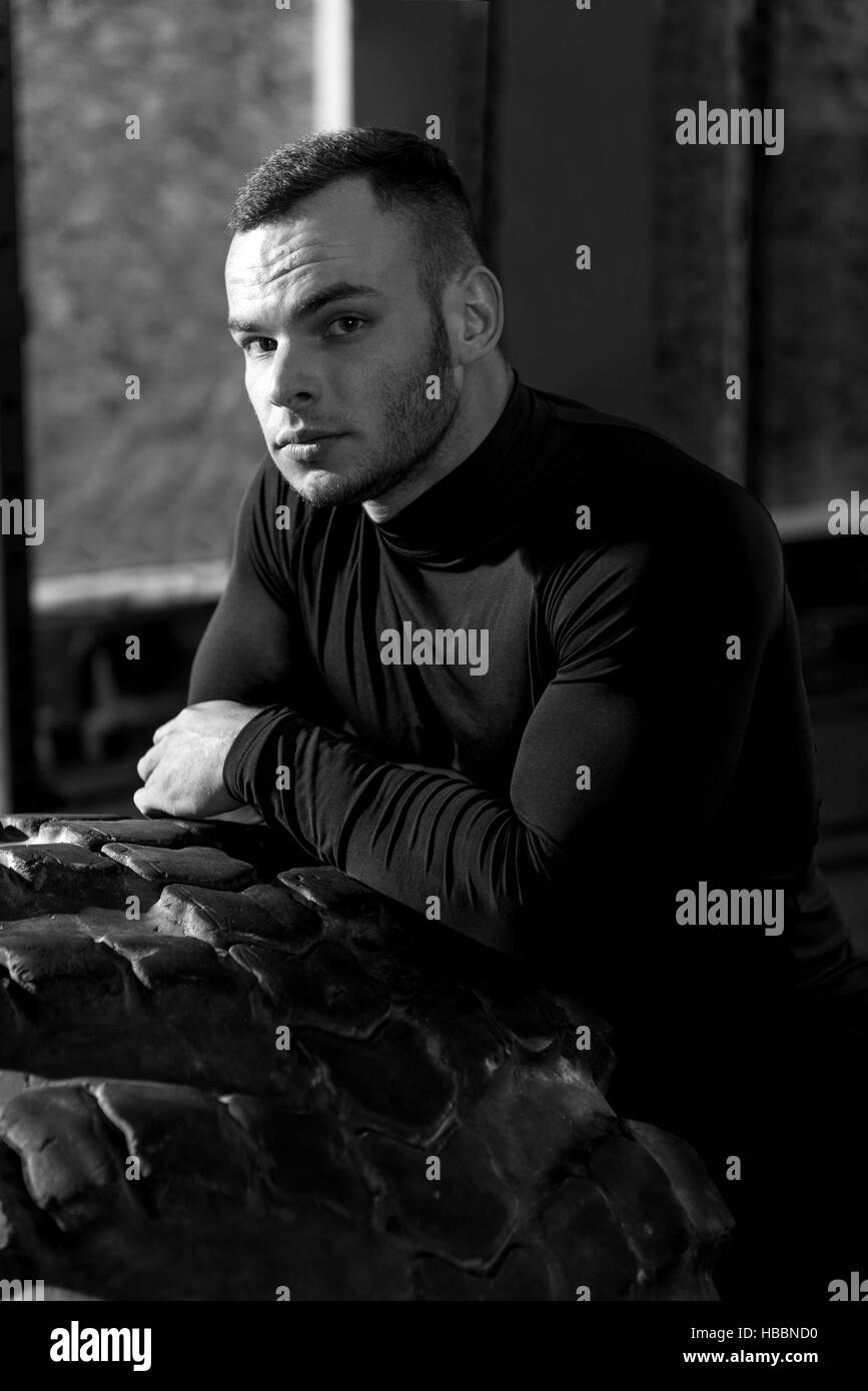 Handsome black man leaning Black and White Stock Photos & Images - Alamy