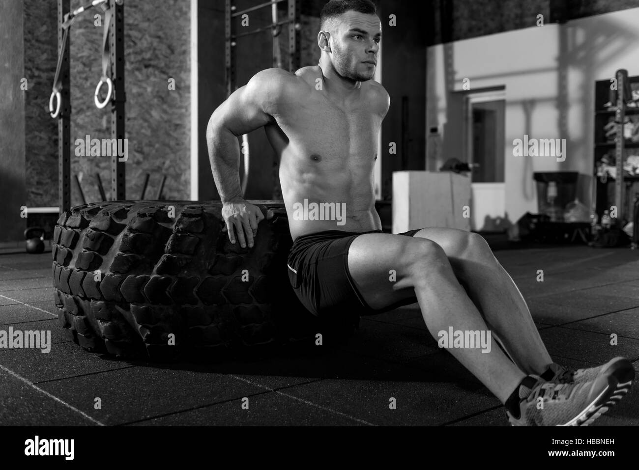 Handsome athletic man building up his muscles Stock Photo - Alamy