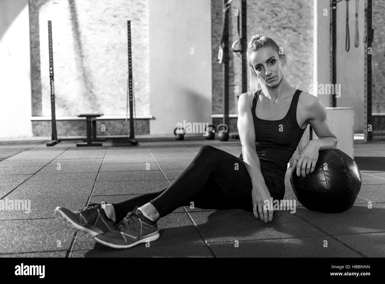Good looking sporty woman leaning on a med ball Stock Photo - Alamy