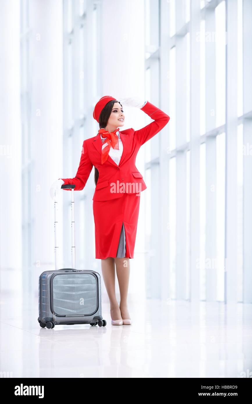 Smiling stewardess at airport Stock Photo - Alamy