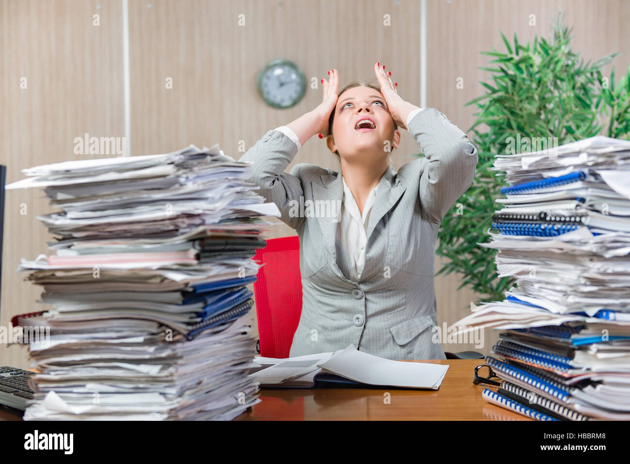 Woman under stress from excessive paper work Stock Photo - Alamy