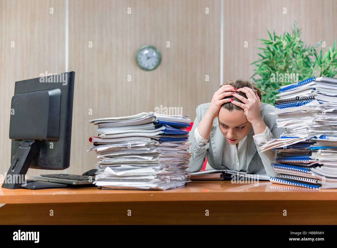 Woman under stress from excessive paper work Stock Photo - Alamy