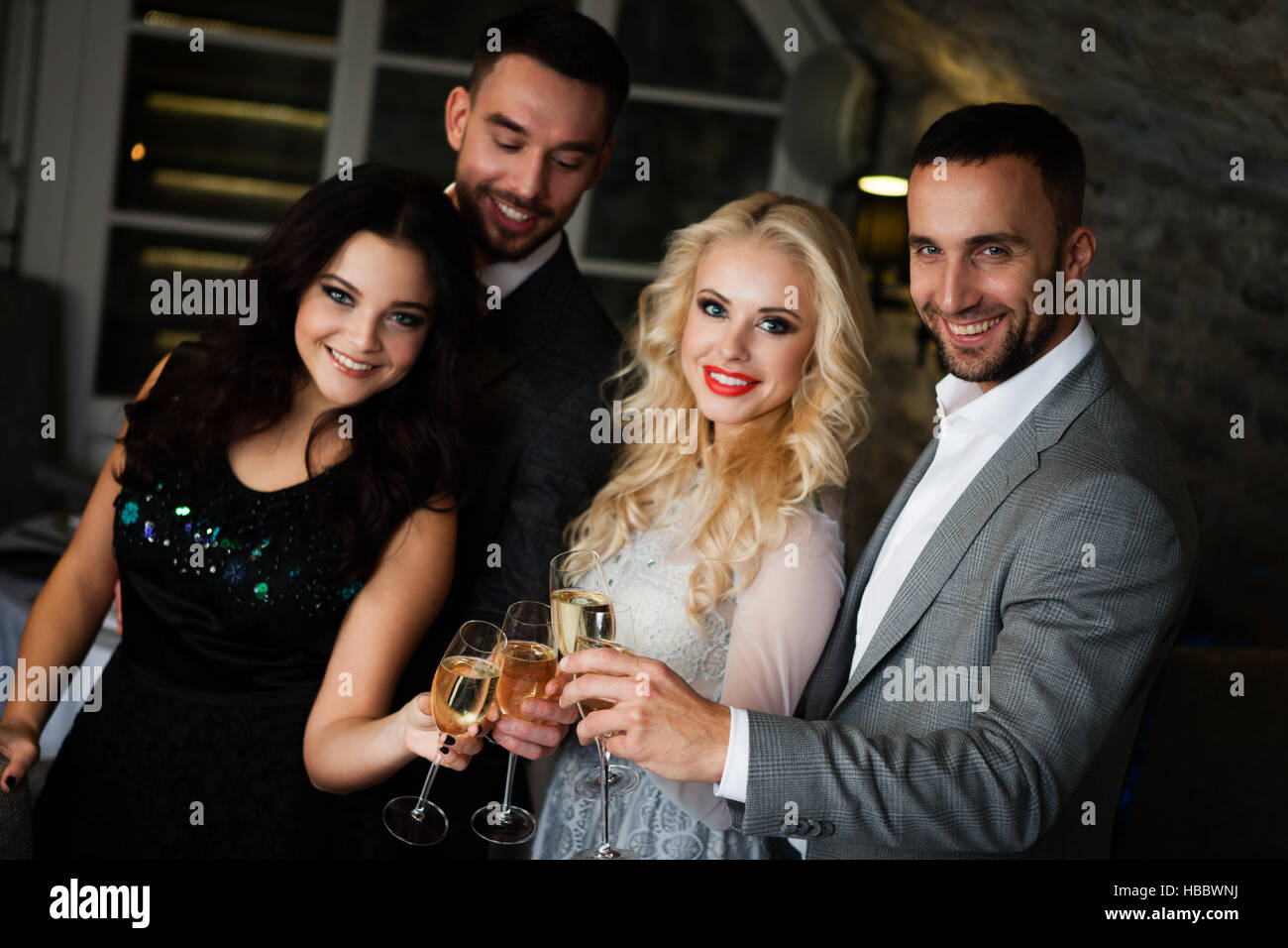 Four friends celebrating Stock Photo - Alamy