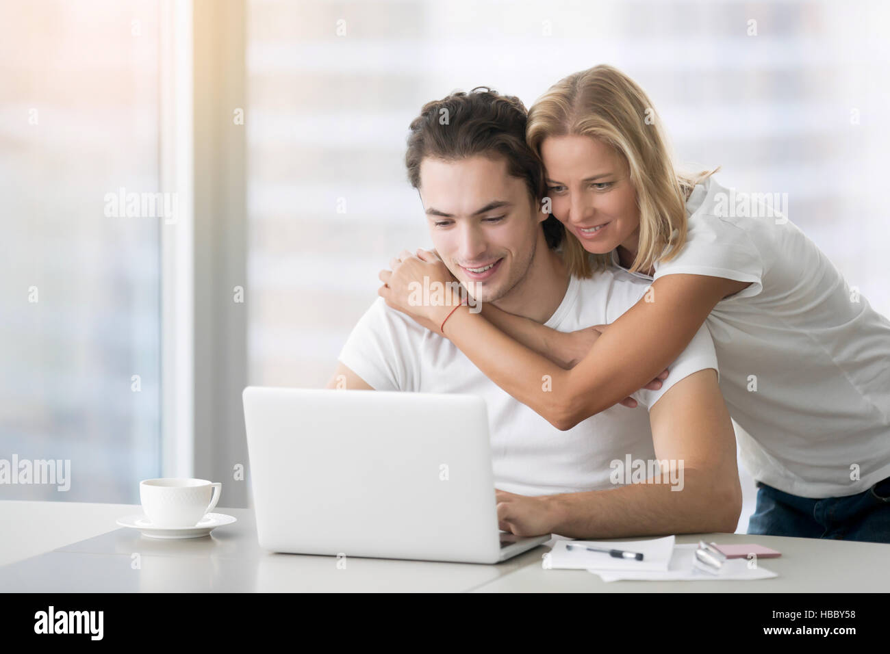 Young happy couple with laptop Stock Photo - Alamy